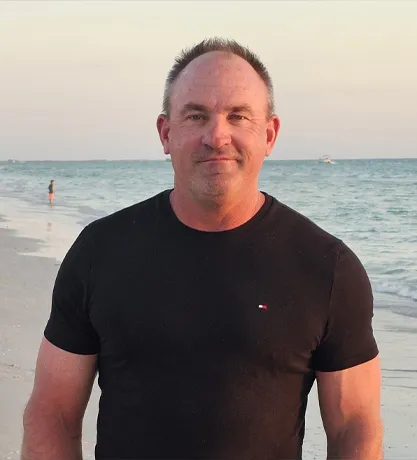 headshot of Tom on the beach