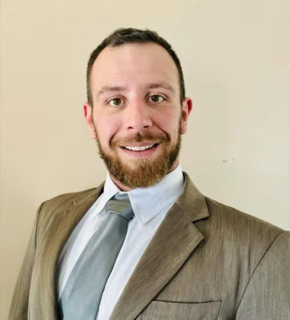 headshot of Justin in a suit